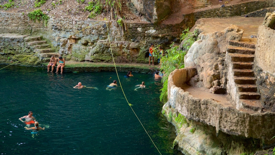 Cenote Zaci which includes swimming and a lake or waterhole as well as a small group of people