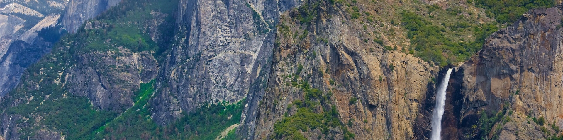 Tunnel View which includes mountains, a waterfall and forests