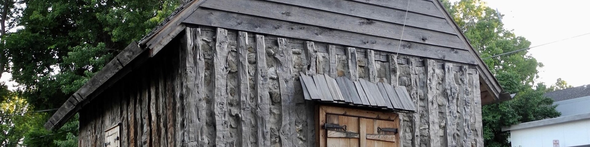 "The first St. Charles Borromeo Church, like this one, was constructed of vertical, hewn logs placed directly in the ground: an architectural style unique to the French in the New World during the 17th and 18th centuries. The church has been rebuilt on its original location. Jesse Francis, a local preservationist with 20 years experience restoring 18th French log buildings, directed the reconstruction. The work was done completely by with period tools in the manner of the 18th century. The church is part of an on-going historical interpretive program based on a re-creation of daily activities in this old French village."