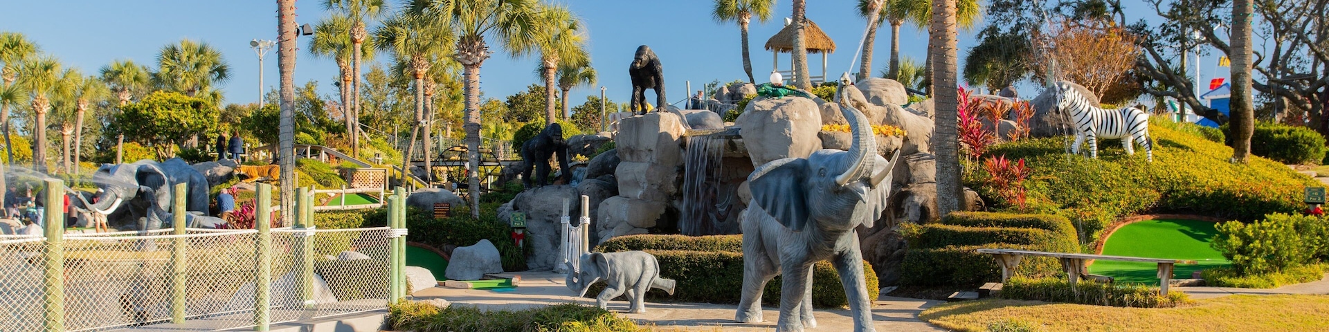 Coconut Creek Family Fun Park featuring a fountain, a garden and outdoor art