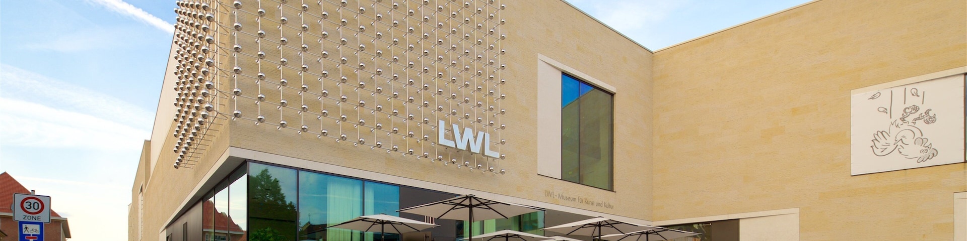 Westphalian State Museum for Art and Cultural History which includes modern architecture and outdoor eating as well as a small group of people