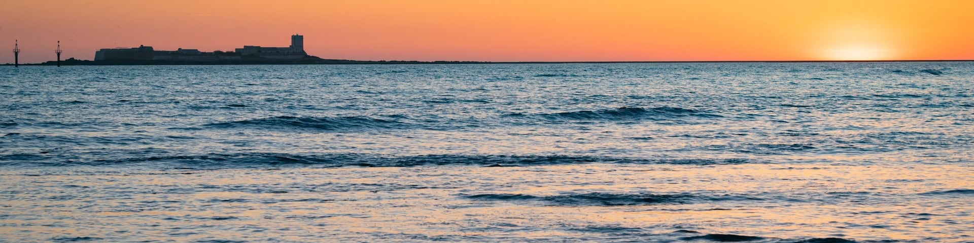 La Barrosa Beach which includes a sunset and general coastal views