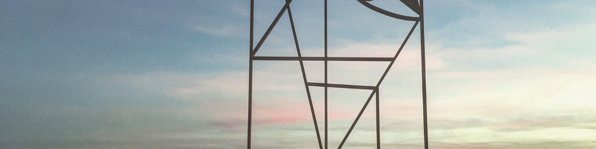 An artwork made by Almada Negreiros. In the other side of the river you can see Almada, a suburb of Lisbon with the same name as the artist