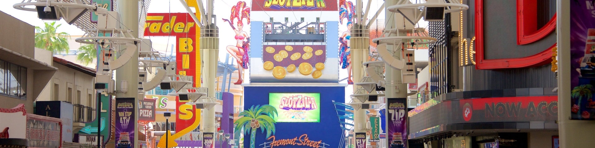 Downtown Las Vegas showing signage as well as a small group of people