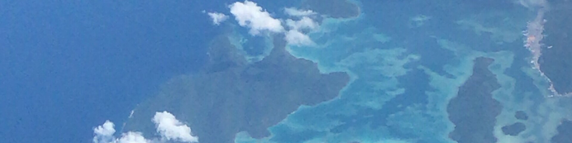 Looked down to find some stunning natural beauty. A cluster of #islands off the eastern coast of #Malaysia #beautiful shades of blues and greens. #view from my #airplane window #middleofnowhere over the south #China #sea #lifeatexpediagroup
