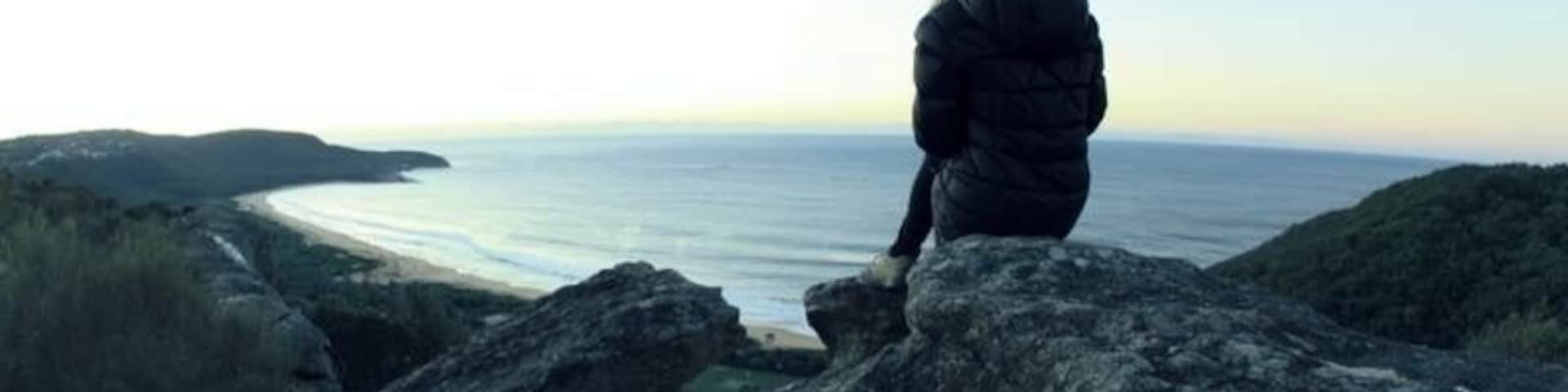 From The Scenic Road (towards Hardys Bay Wharf) take Nukara Ave and follow the dirt road up the cliff for this incredible viewing point of Killcare Beach.