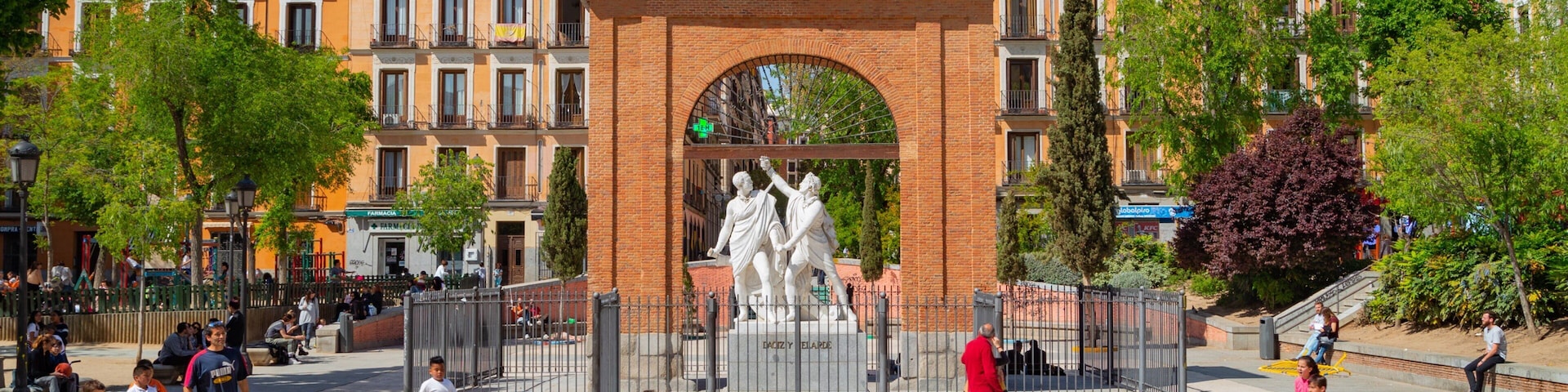 Malasana which includes a square or plaza and a statue or sculpture as well as children