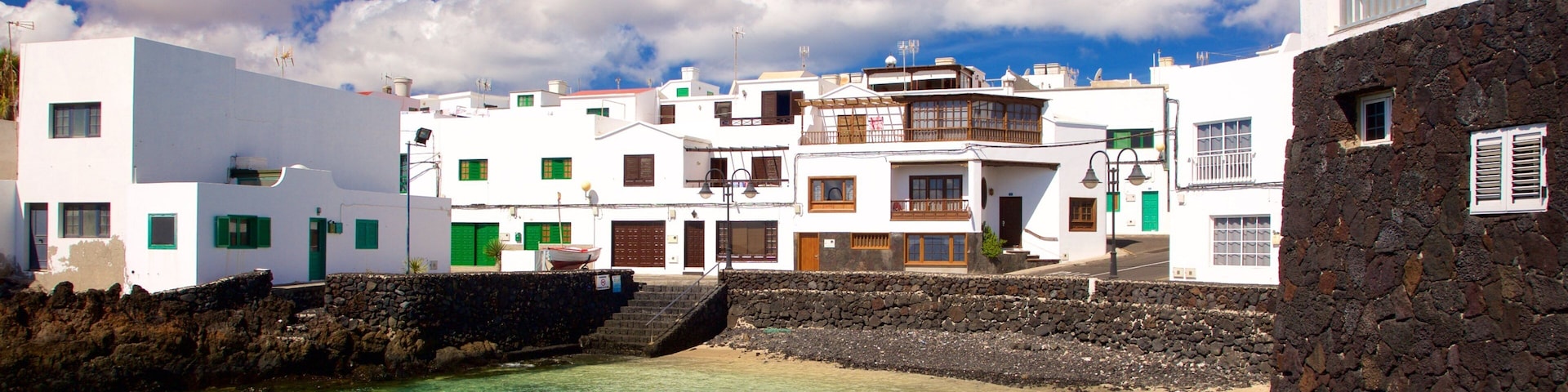 Lanzarote featuring rocky coastline, general coastal views and a coastal town