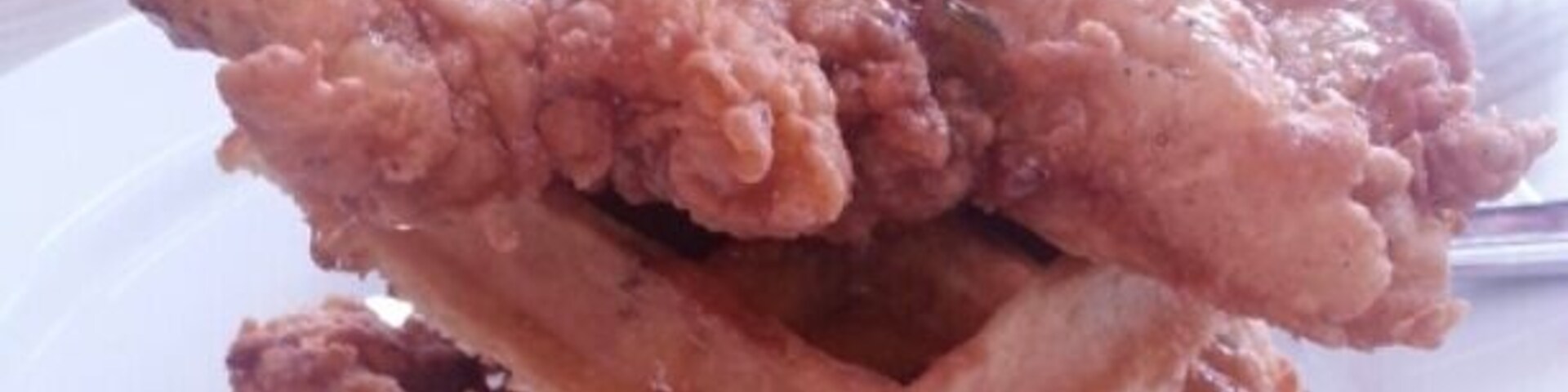 Chicken and waffles at the art museum. It is the best chicken and waffles I have ever had. It is waffles and chicken covered in a jalape?o maple syrup, all topped with a strawberry.