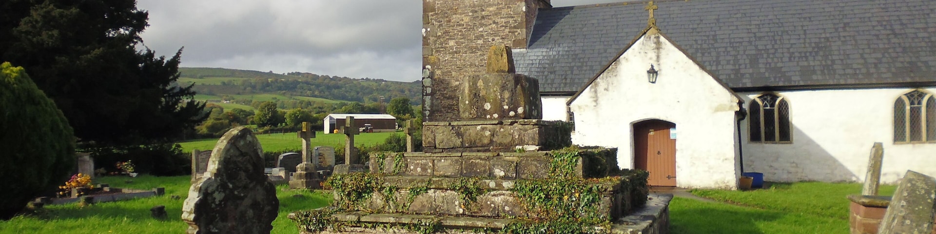 Remains of medieval preaching cross in the graveyard of St Peter's Church. Henllys, Cwmbran. This is a scheduled ancient monument in Torfaen.