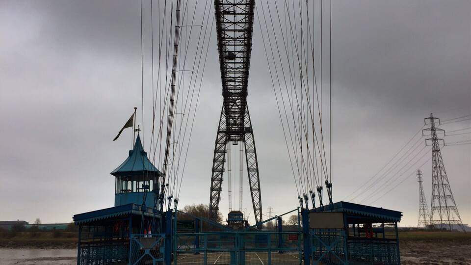The Newport Transporter Bridge. A bridge hanging from wires and moved across the river like a crane.