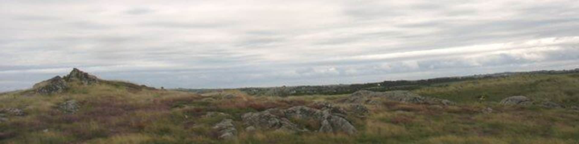 The Gorsedd-y-Person outcrop south of Eilian House This outcrop of rock by the railway line is surrounded by duneland. Gorsedd-y-Person means "throne of the parson".