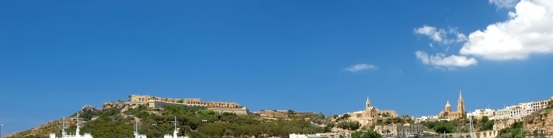 The town of Mġarr grew up around the shallow harbour which shares its name. Ferry services to Malta were in operation by 1241, and fishing was already established. While the area around the harbour was developed over the following centuries, there was little development of the harbour itself until 1841, when a breakwater was constructed to provide more shelter to the port. This breakwater was strengthened and extended several times up to 1906. A larger breakwater was constructed between 1929 and 1935, and two more in 1969; on the completion of the latter, the area of the port was expanded to 121,400 square metres.