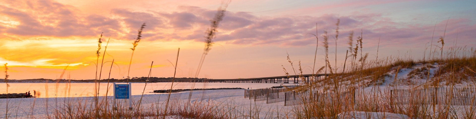 Destin showing general coastal views, a sandy beach and a sunset