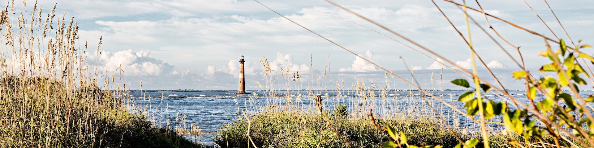 Folly Beach which includes a lighthouse and general coastal views