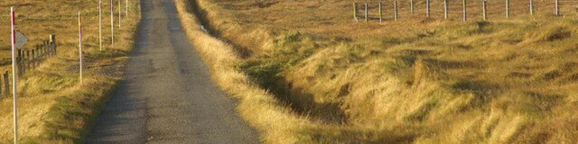 Fetlar Telephone Exchange This is the main road through Fetlar. The tower folly beside Brough Lodge can be seen in the distance.