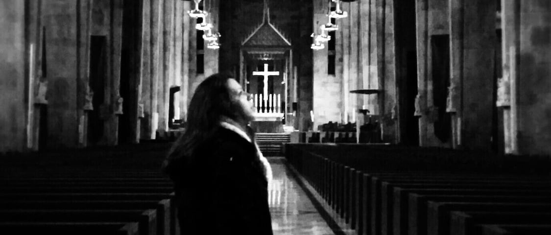 It's difficult not to stand and stare in awe inside the Cathedral of Mary Our Queen. I captured this image of a friend lost in the intricate art of hundreds of stained glass windows lining the cathedral walls.