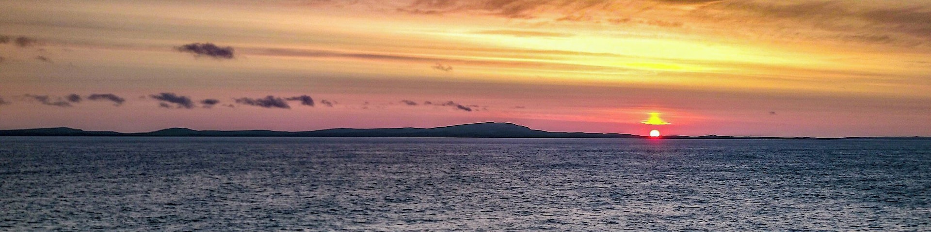 Sunset veiwed from a cruis e ship crossing the Arctic circle.