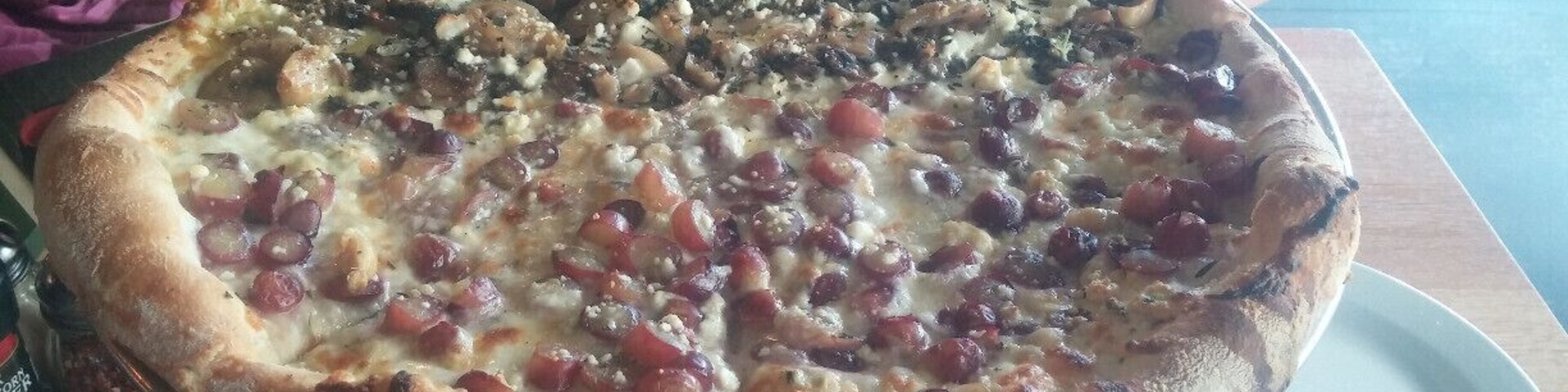 Half and Half! The back half includes roasted mushrooms, feta, caramelized onions, roasted & fresh garlic & herbs...and starring on the front half: Red grapes, gorgonzola & fresh rosemary.