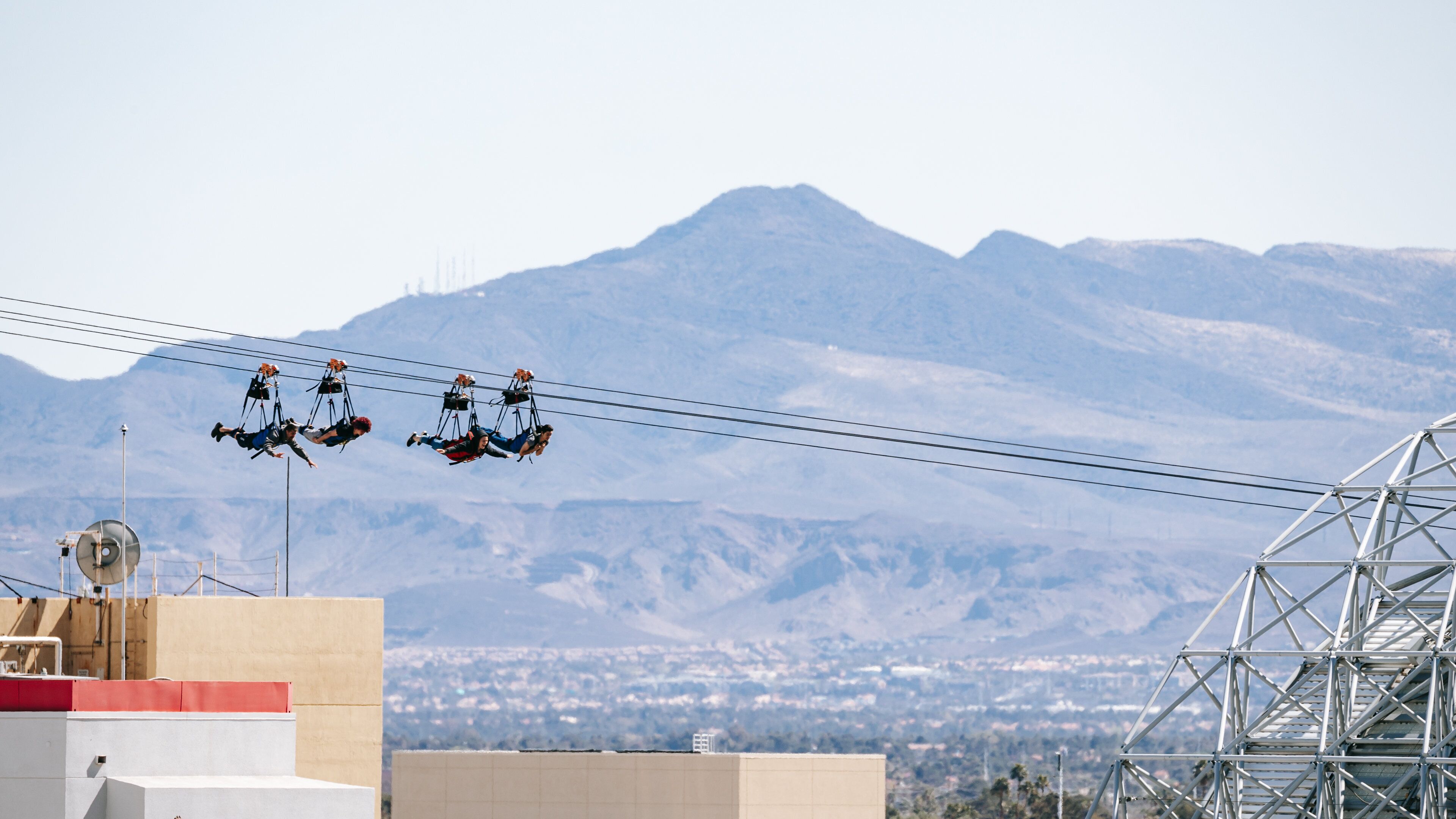 Downtown Las Vegas showing landscape views and zip lining as well as a small group of people