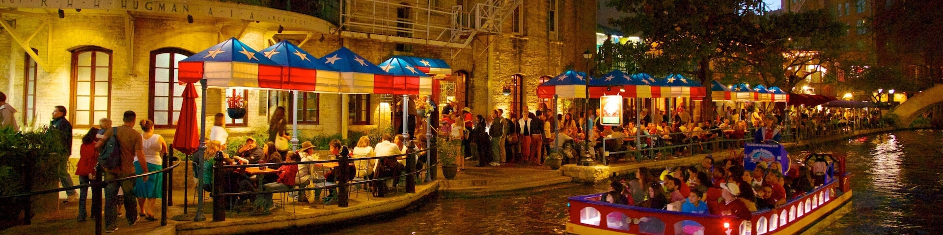 Downtown San Antonio which includes cafe lifestyle, night scenes and boating