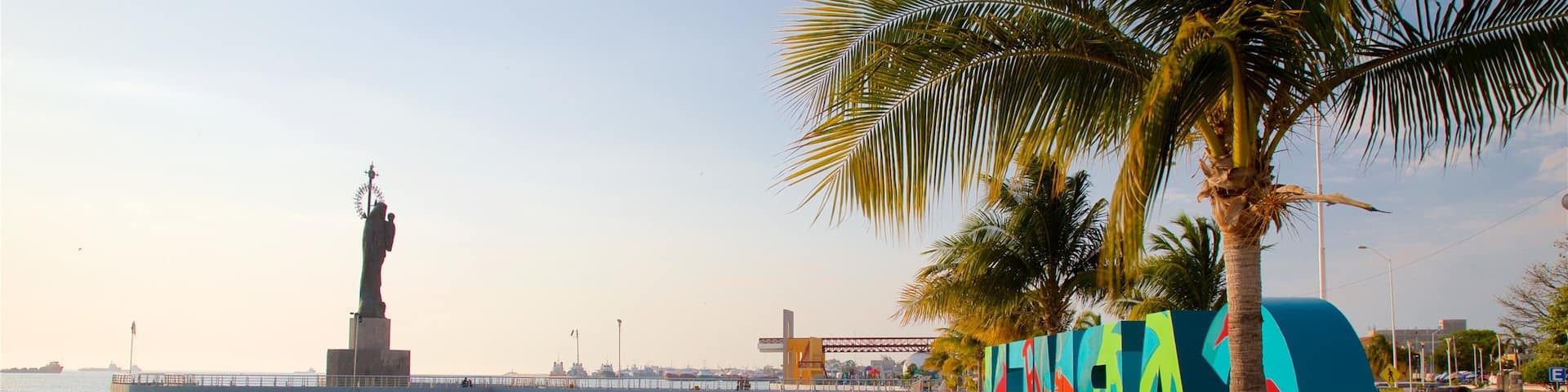 Ciudad del Carmen featuring signage, a statue or sculpture and tropical scenes