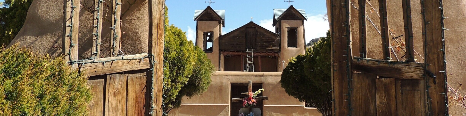 Although a classic example of Spanish Colonial architecture (thick adobe walls, two bell towers and a six-foot crucifix), the small catholic church of El Santuario de Chimaya is probably best known for its supposedly curative powers of “holy dirt” found in its sacristy. 
The National Historic Landmark, located in the Sangre de Cristo Mountains of Chimayo, has been called the “Lourdes of America”, attracting 300,000 pilgrims annually hoping to take home some of the miracle dirt.   
We went home empty handed the day of our visit; a mass was being celebrated at the time of our arrival.   
Follow the High Road to Taos Scenic Byway from Santa Fe to see this site and numerous other authentic historic landmarks.  
 
#architecture